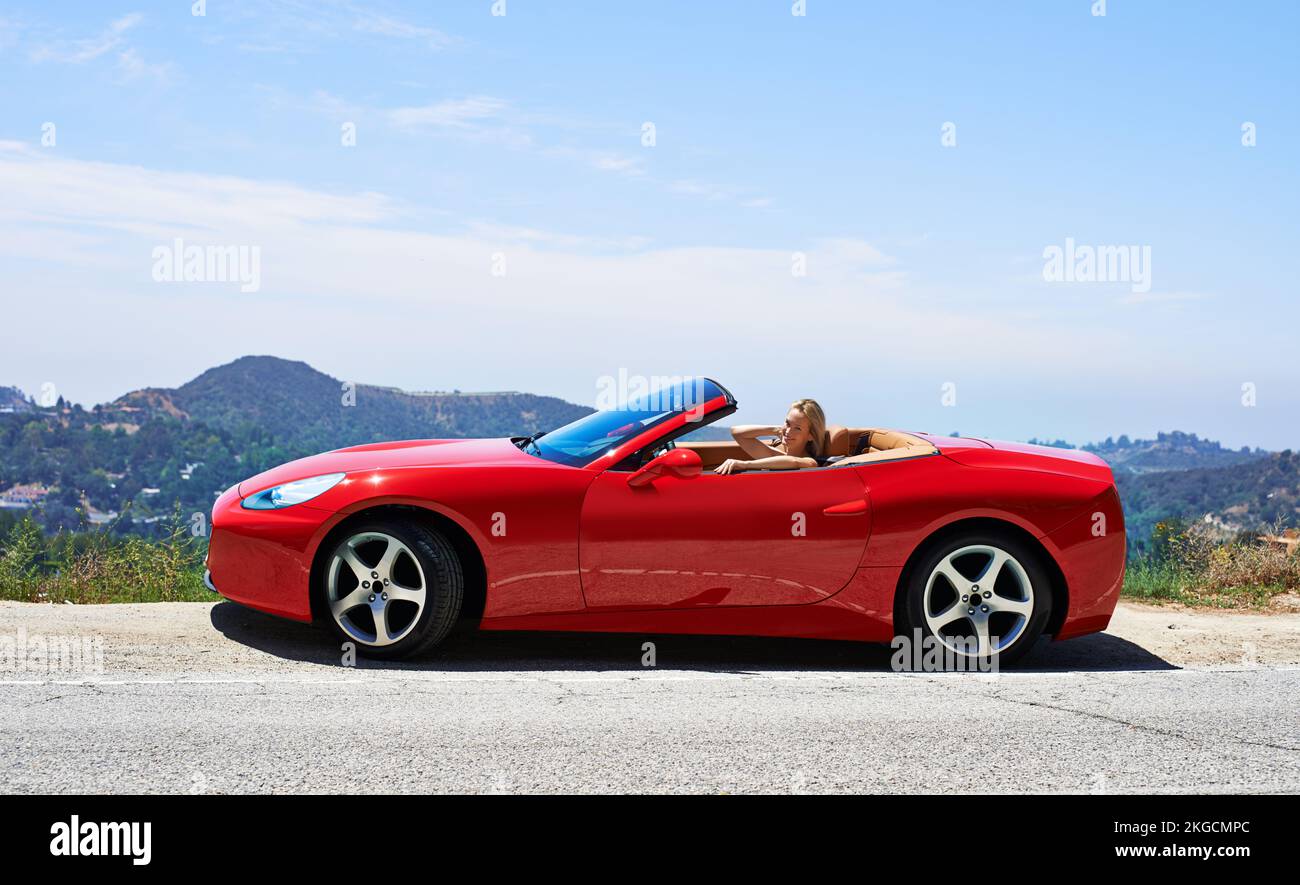 Time for this wheels to hit the road. a young woman driving in a sports ...