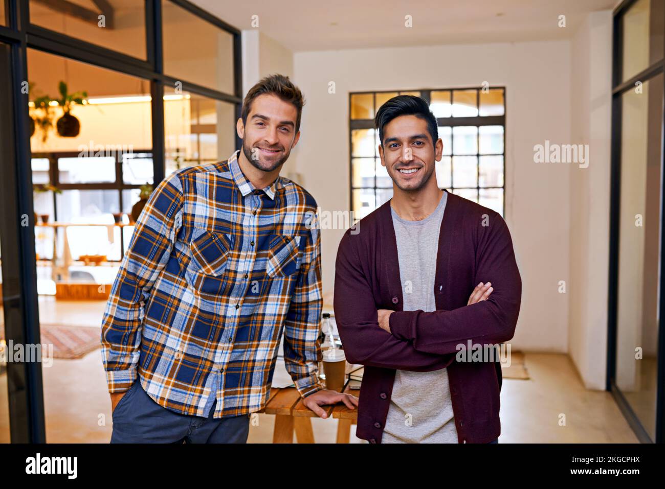 Their creative space. Portrait of two male designers standing in their ...