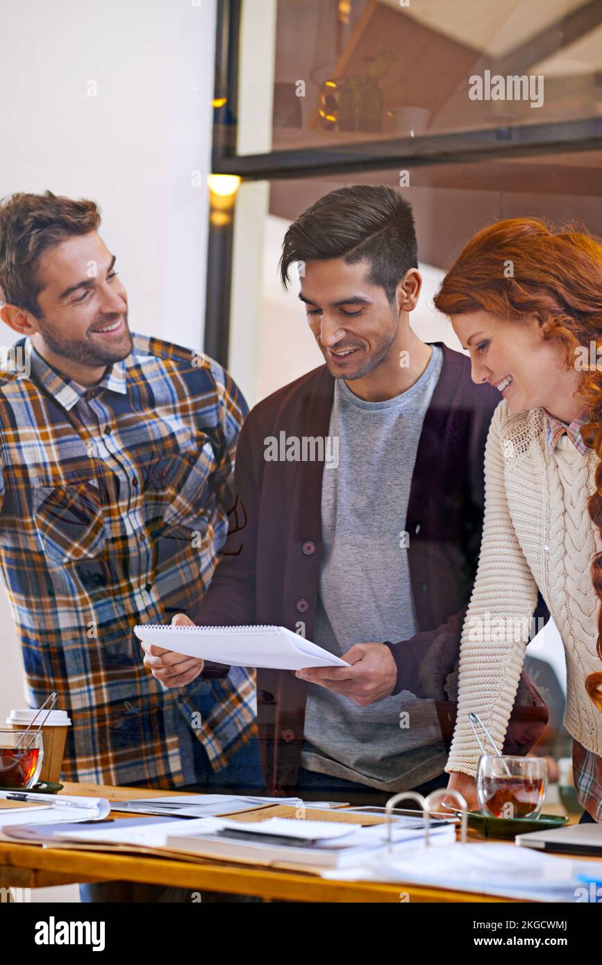 Looking at the final design. a team of young designers discussing their ...