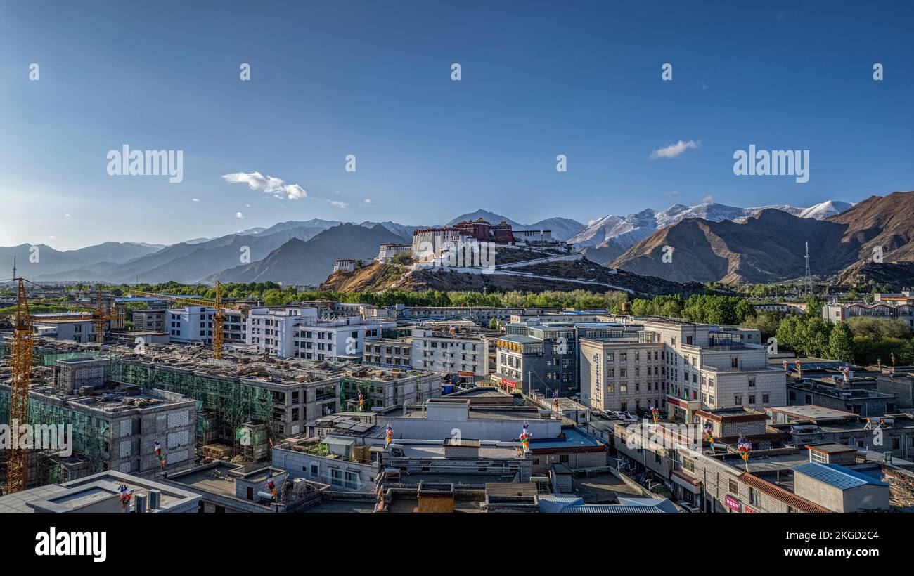 The ancient Potala Palace on a hill from the buildings in Lhasa, Tibet ...