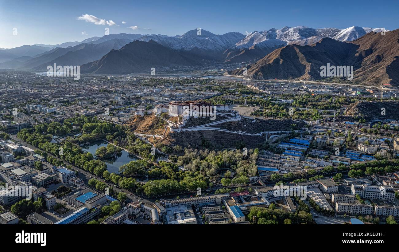 The ancient Potala Palace on a hill from the buildings in Lhasa, Tibet ...