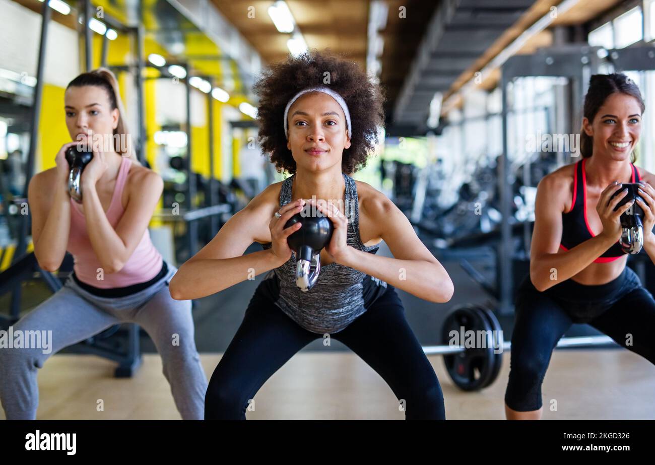 Group of fit people lifting dumbbells during an exercise class at the ...
