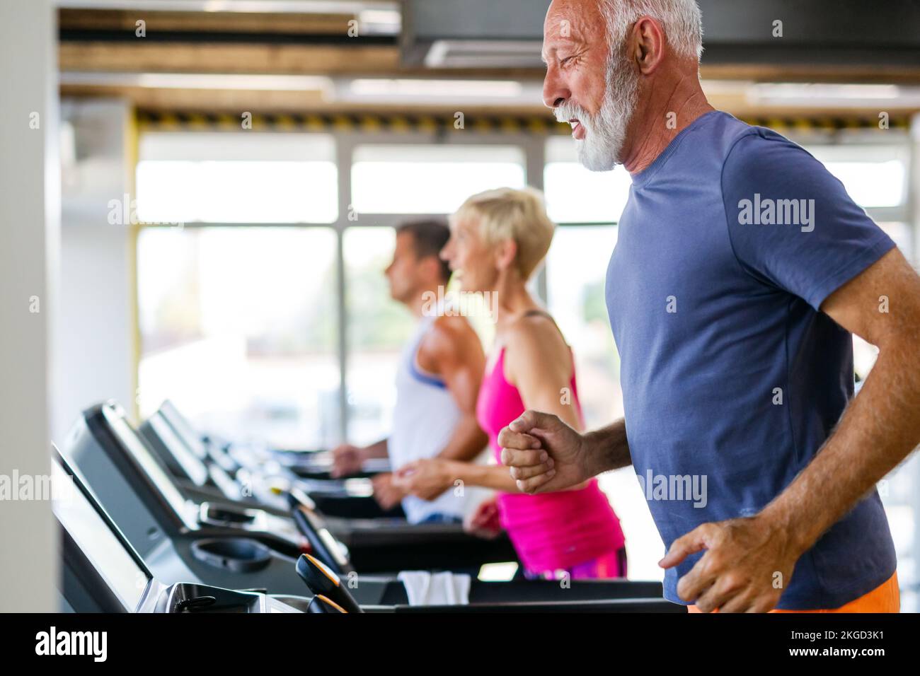 Happy senior people doing exercises in gym to stay fit. People sport ...