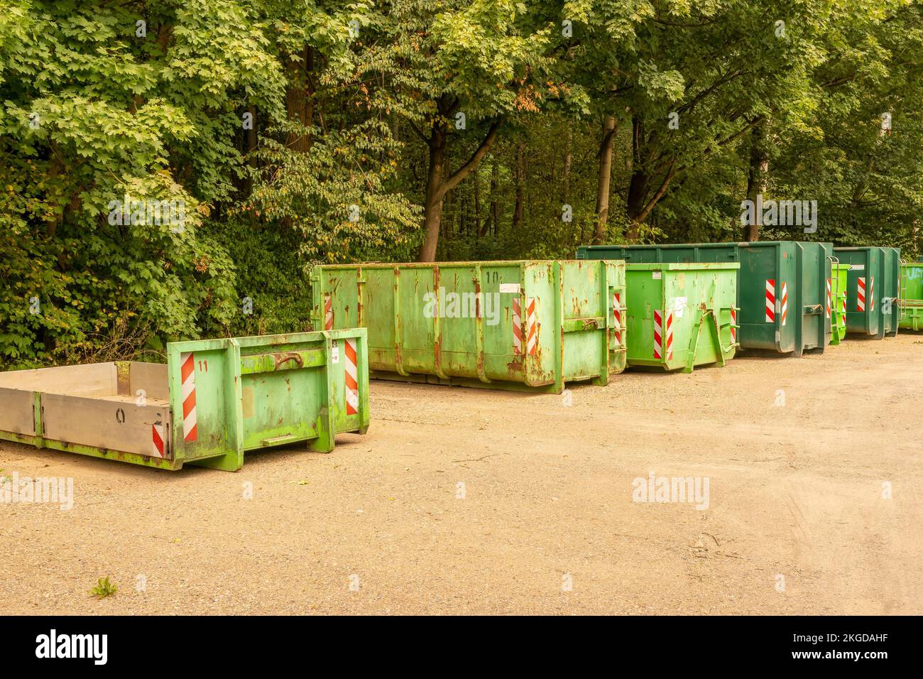 A line of rusty containers near the green trees Stock Photo - Alamy