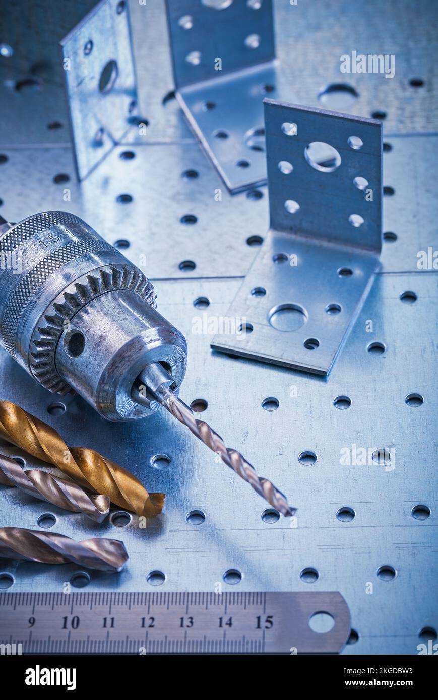 Angle fasteners bits ruler and metal drill on perforated metallic ...