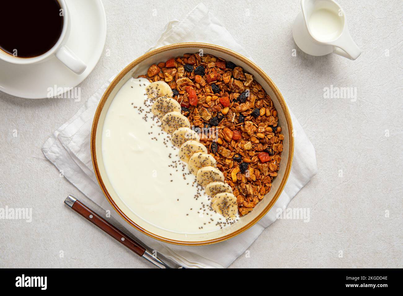 Portion of granola with banana and yoghurt Stock Photo - Alamy
