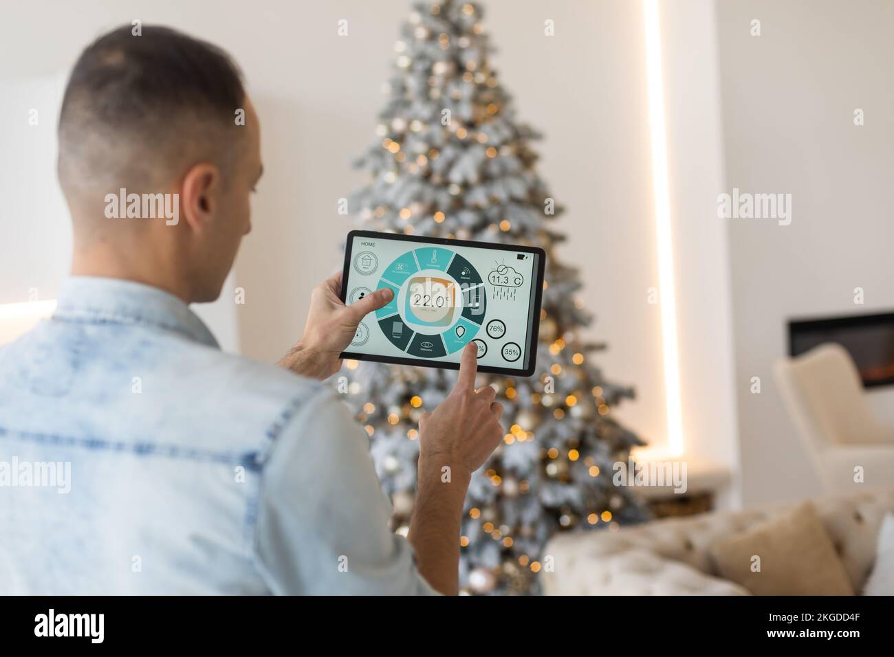Man use smart home control on tablet in Christmas Stock Photo - Alamy
