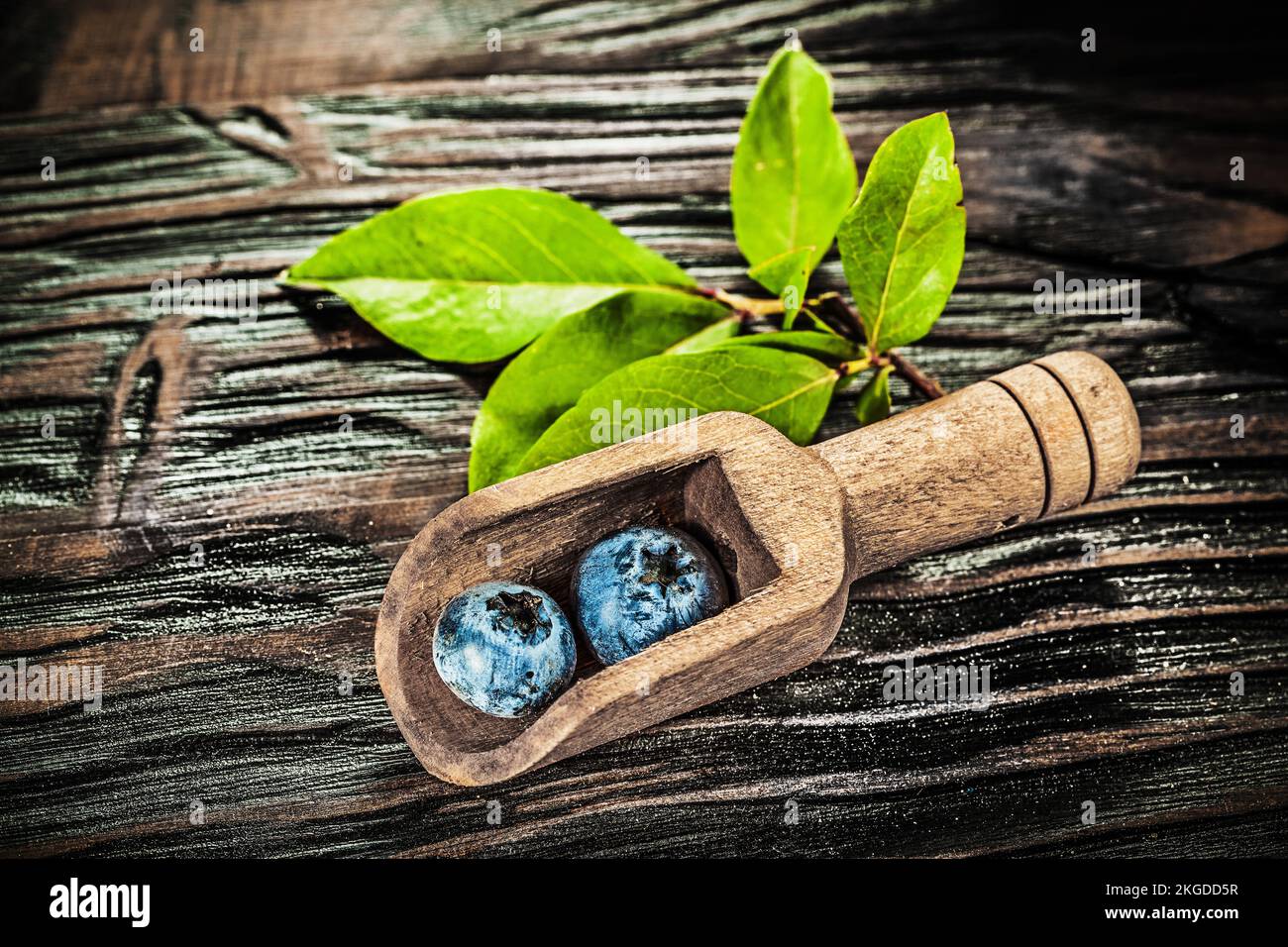 Bilberries green leaf in wooden spoon Stock Photo - Alamy