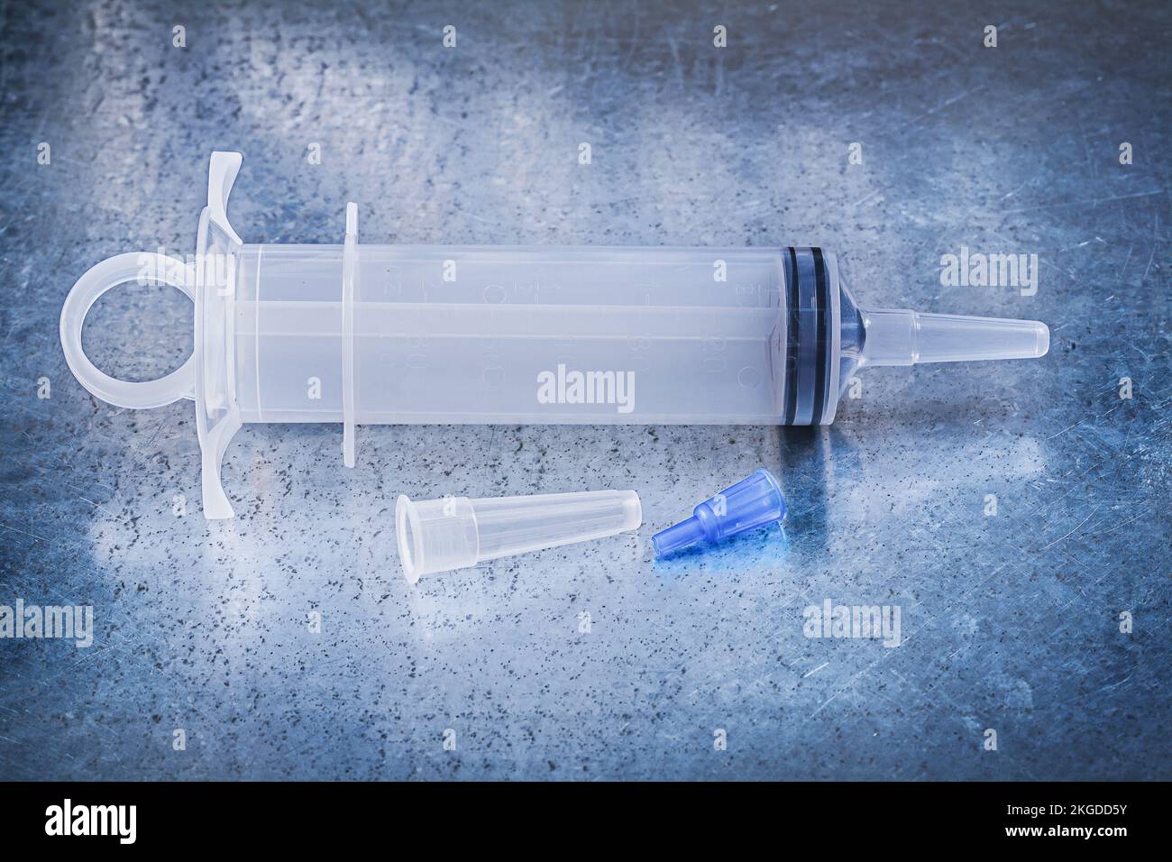 Big single-use syringe on metallic background top view medicine concept ...
