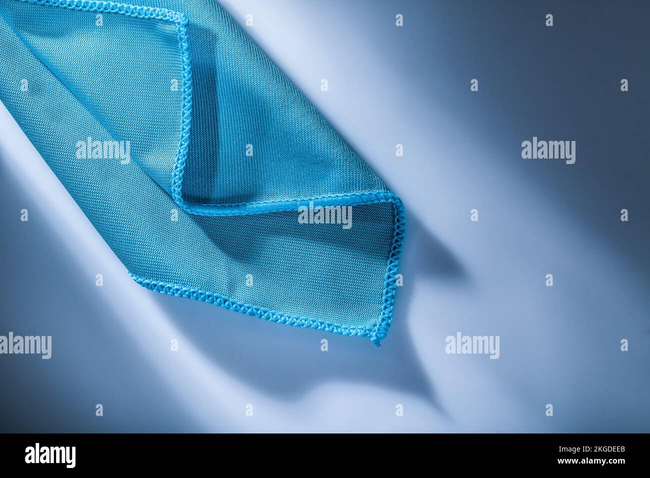 Blue cleaning cloth on white background Stock Photo - Alamy