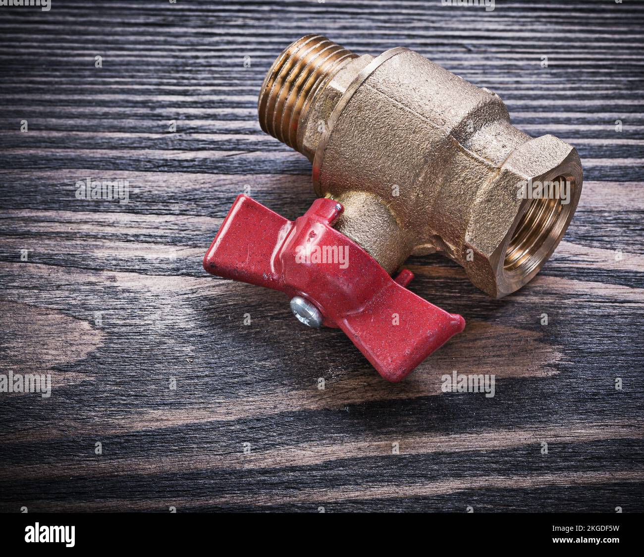 Brass gate valve on wooden background plumbing concept Stock Photo - Alamy