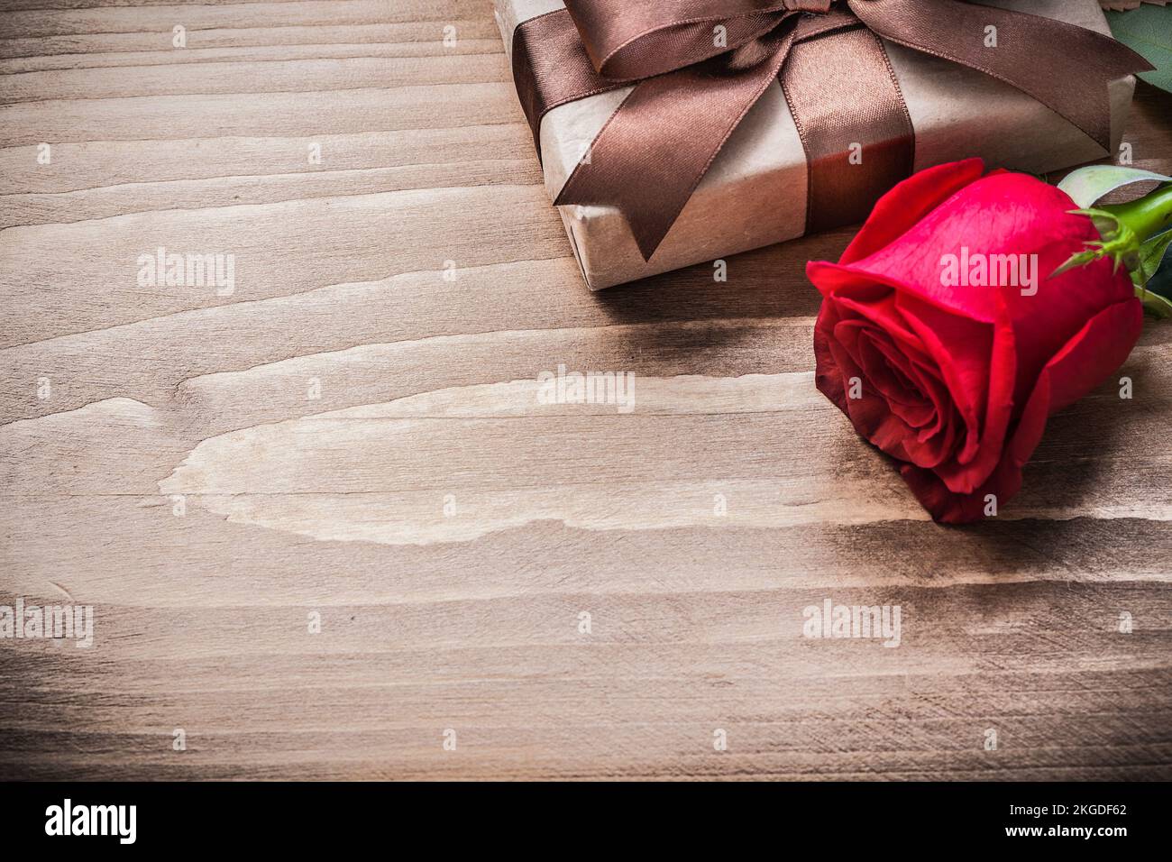 Boxed present expanded rose head on wooden board holiday concept Stock ...