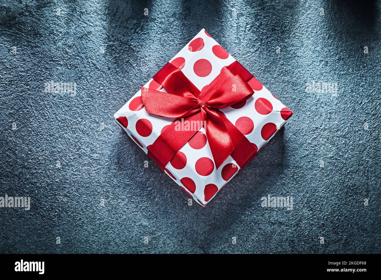 Boxed present with tied bow on black background holidays concept Stock ...