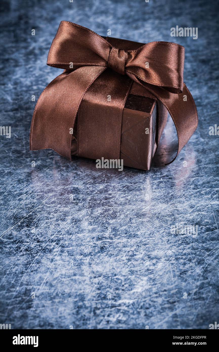Boxed present with tied bow on metallic background holiday concept ...