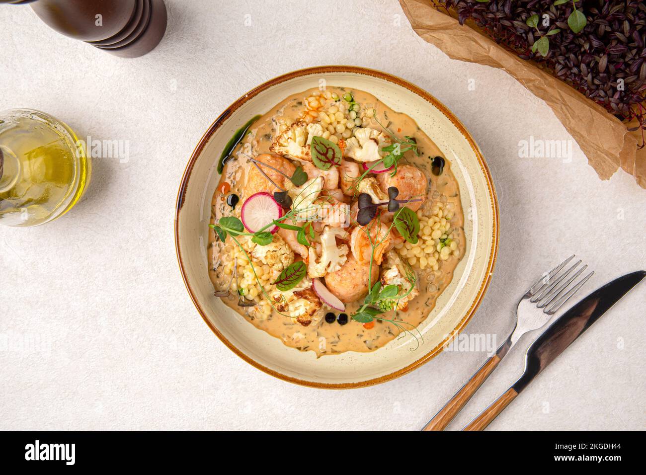 Portion of ptitim dish with seafood and herbs Stock Photo - Alamy
