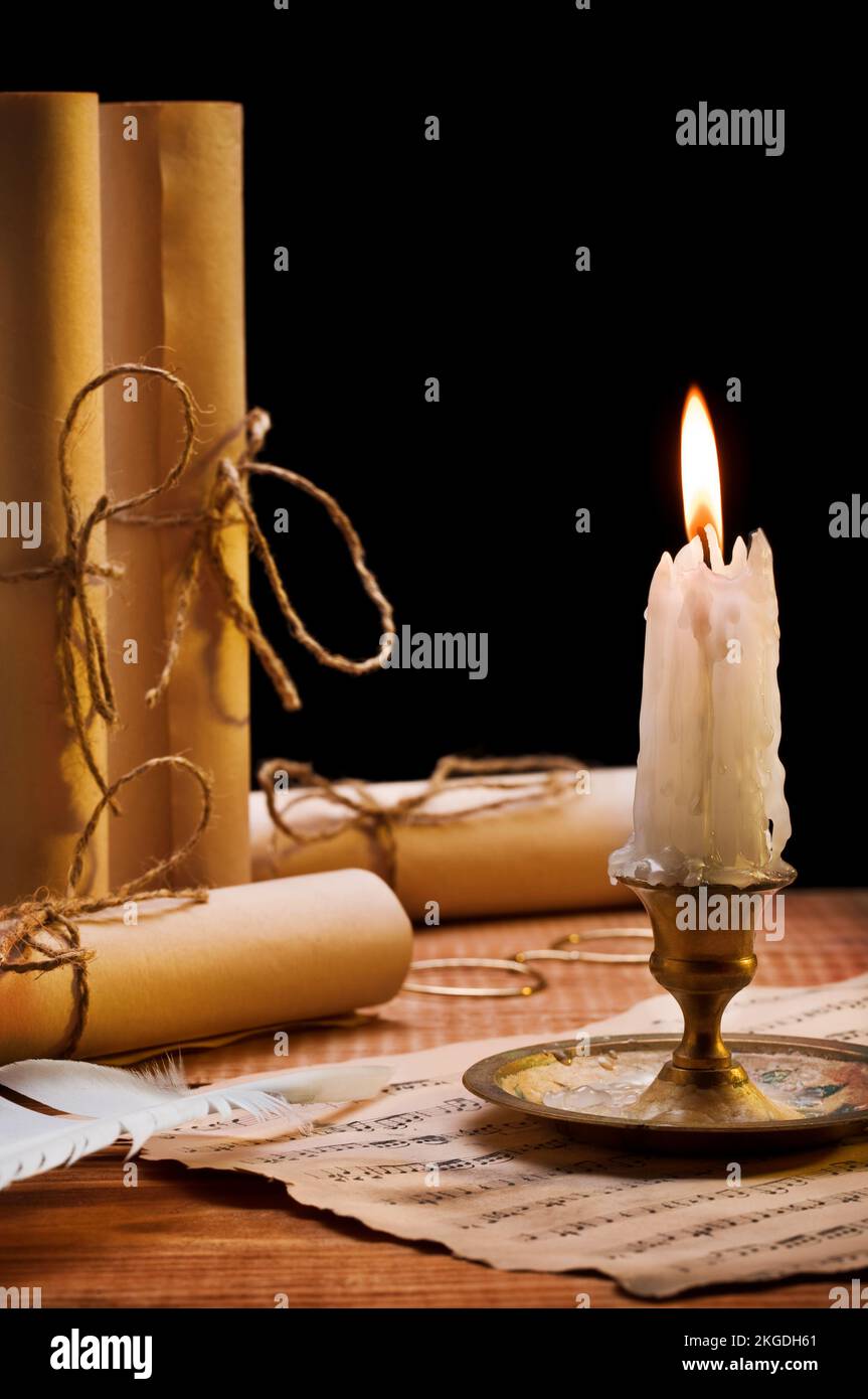 burning candle and antique items Stock Photo - Alamy