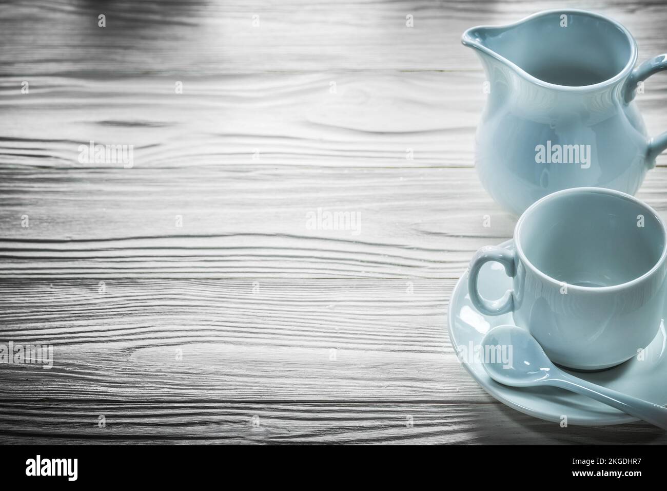Ceramic cup saucer teaspoon creamer on wooden board Stock Photo - Alamy