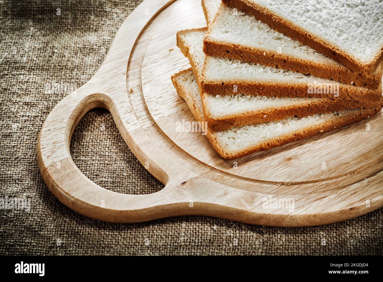 Chopping board sliced toast bread on textured sacking background Stock ...