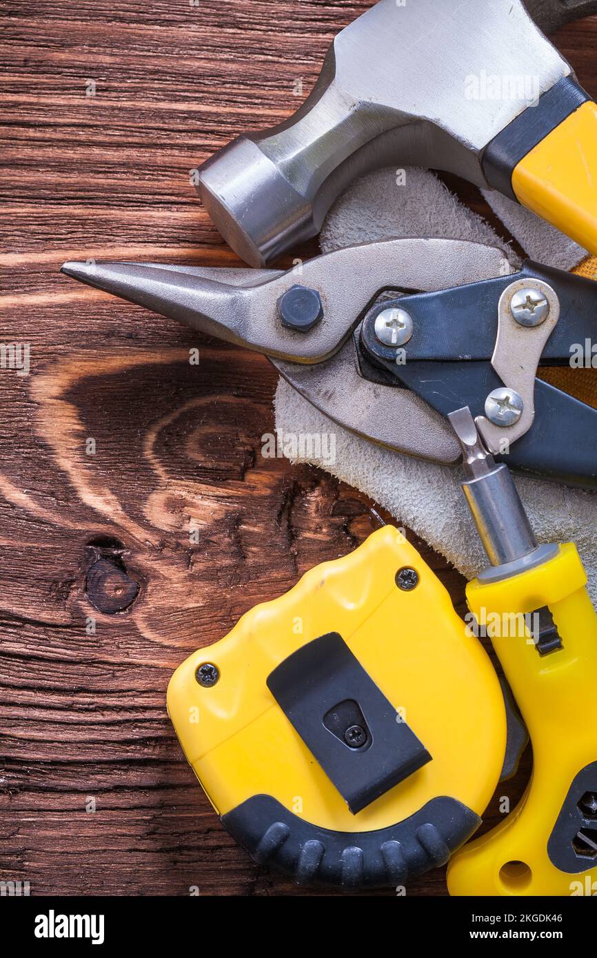 Claw hammer construction glove tape-line screwdriver and nippers on ...