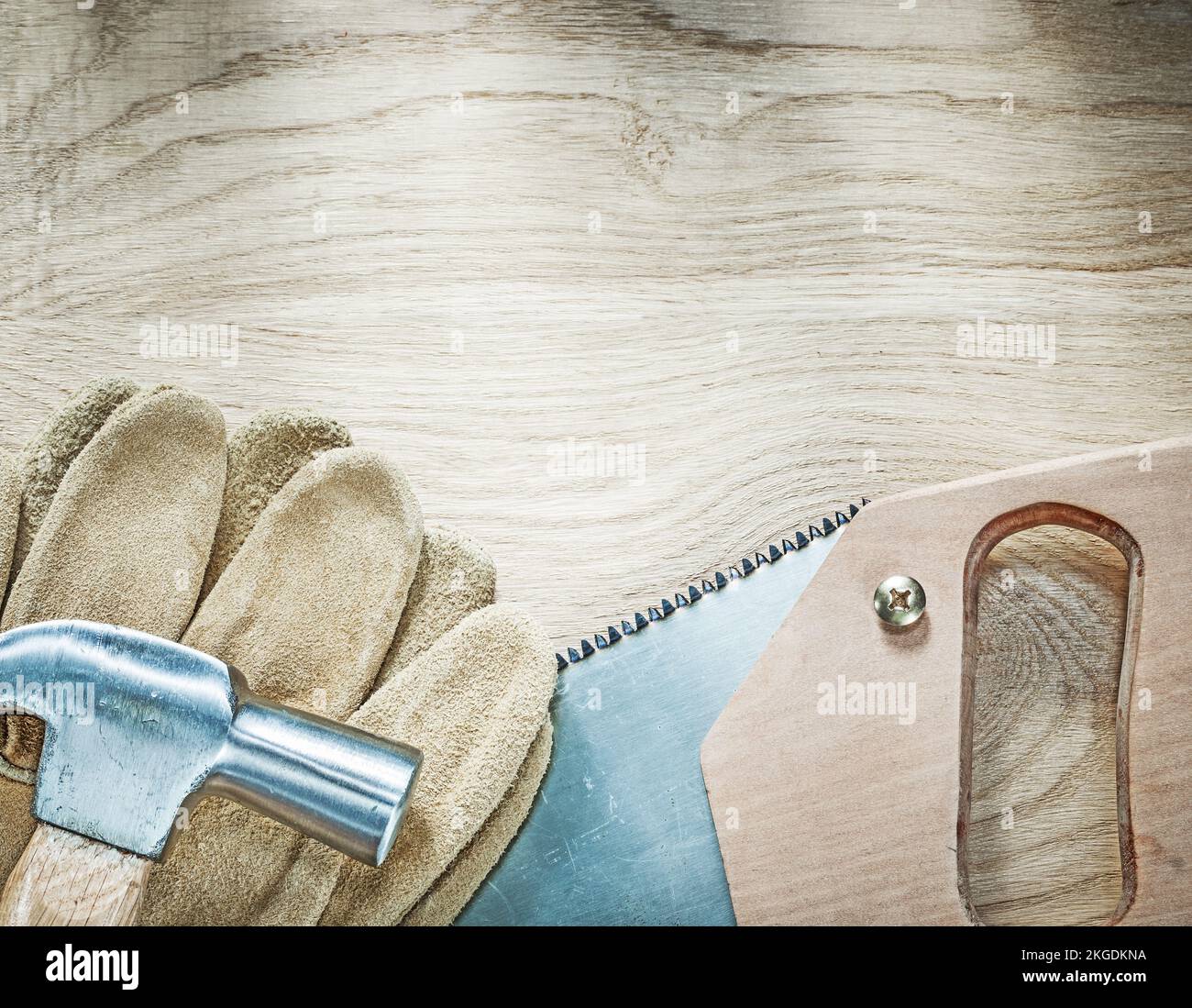 Claw hammer leather safety gloves stainless handsaw on wood board ...