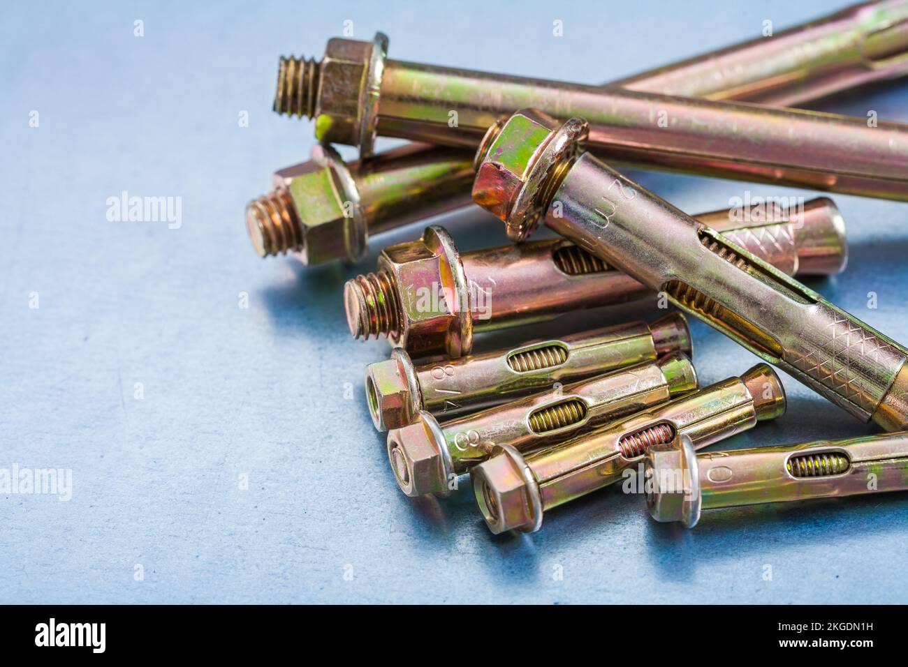 Close-up view of metal anchor bolts with construction nuts on metallic ...