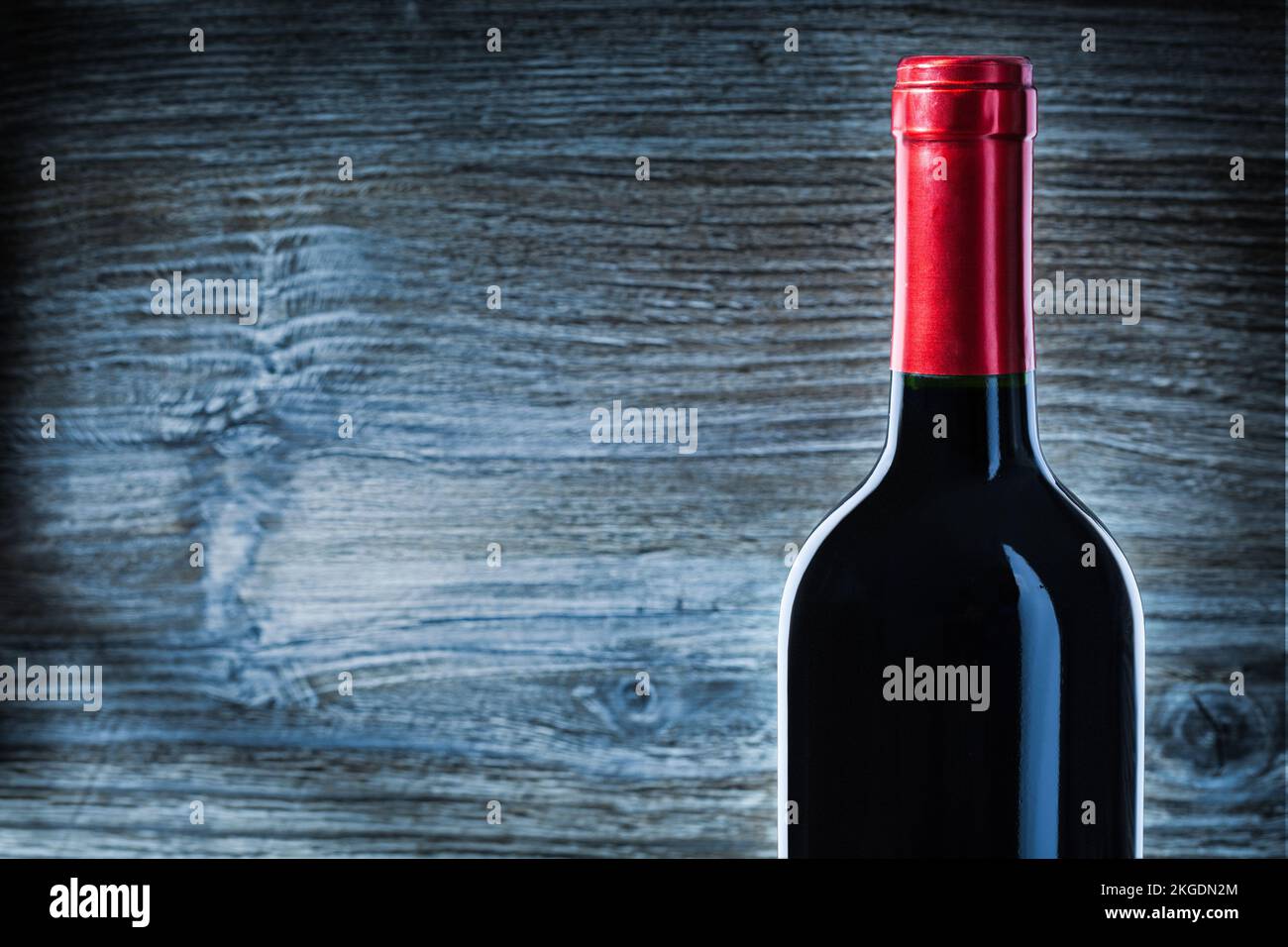 close up view on top of bottle with red wine on vintage wood Stock ...