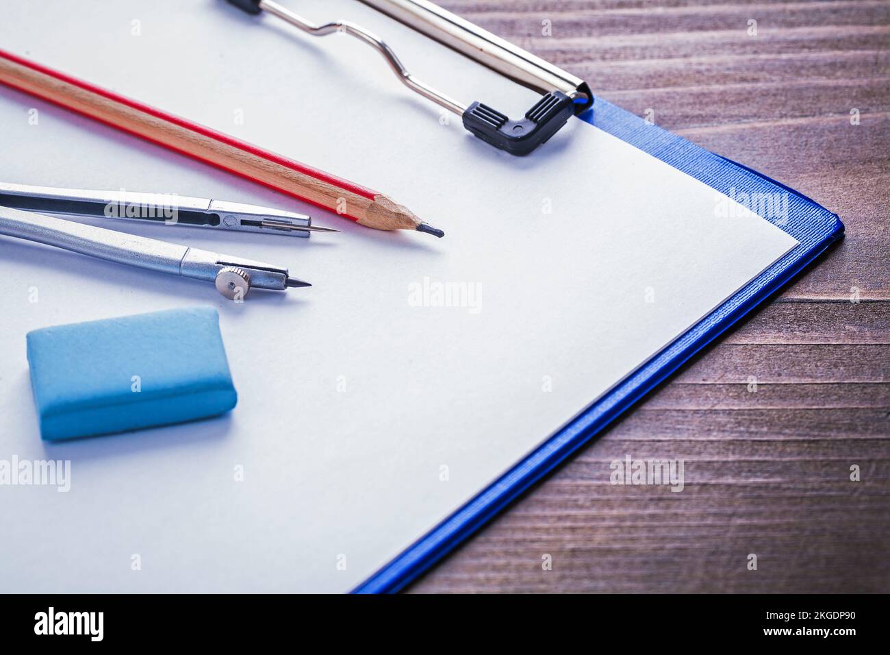 compass and pencil eraser clipboard and paper on vintage wooden board ...