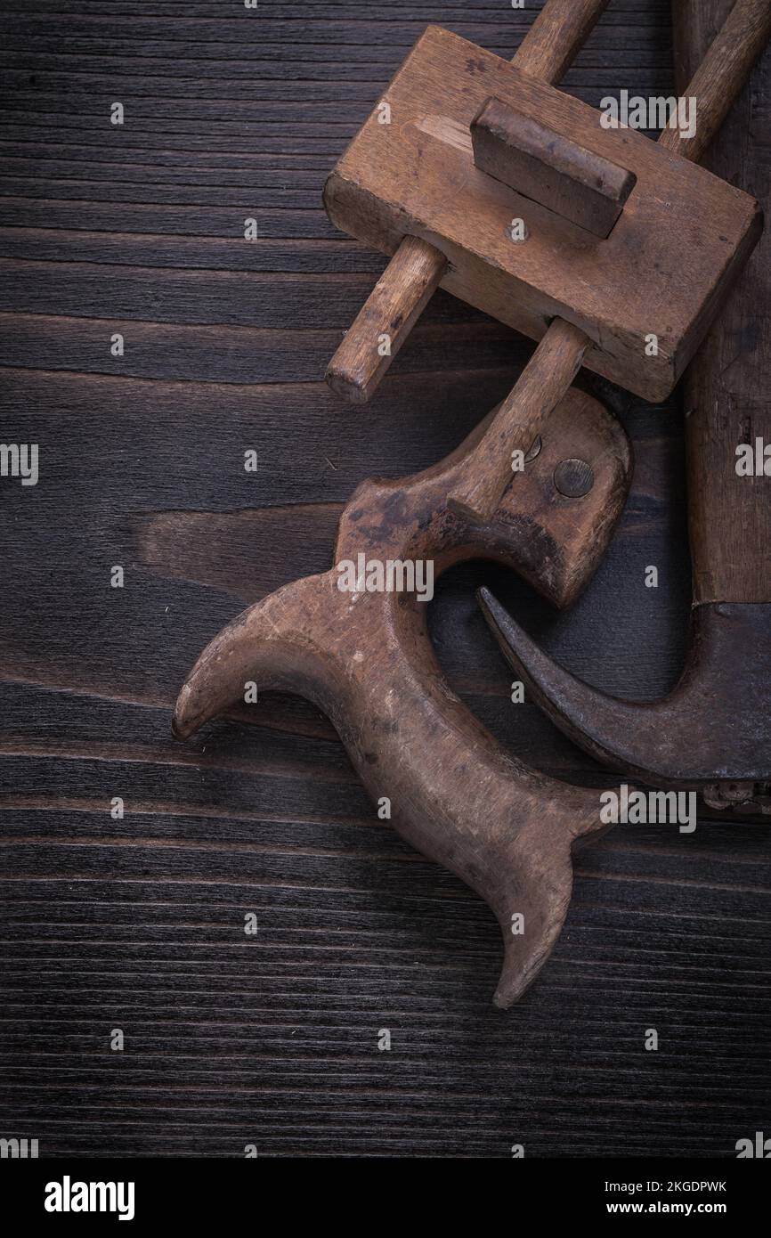 Composition of dark hand saw vintage marking gauge claw hammer Stock ...