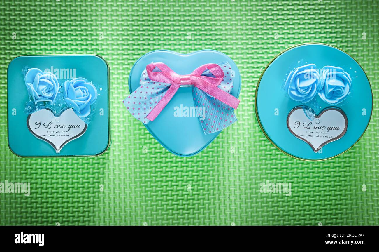 Composition of metal blue packed present boxes on green background ...
