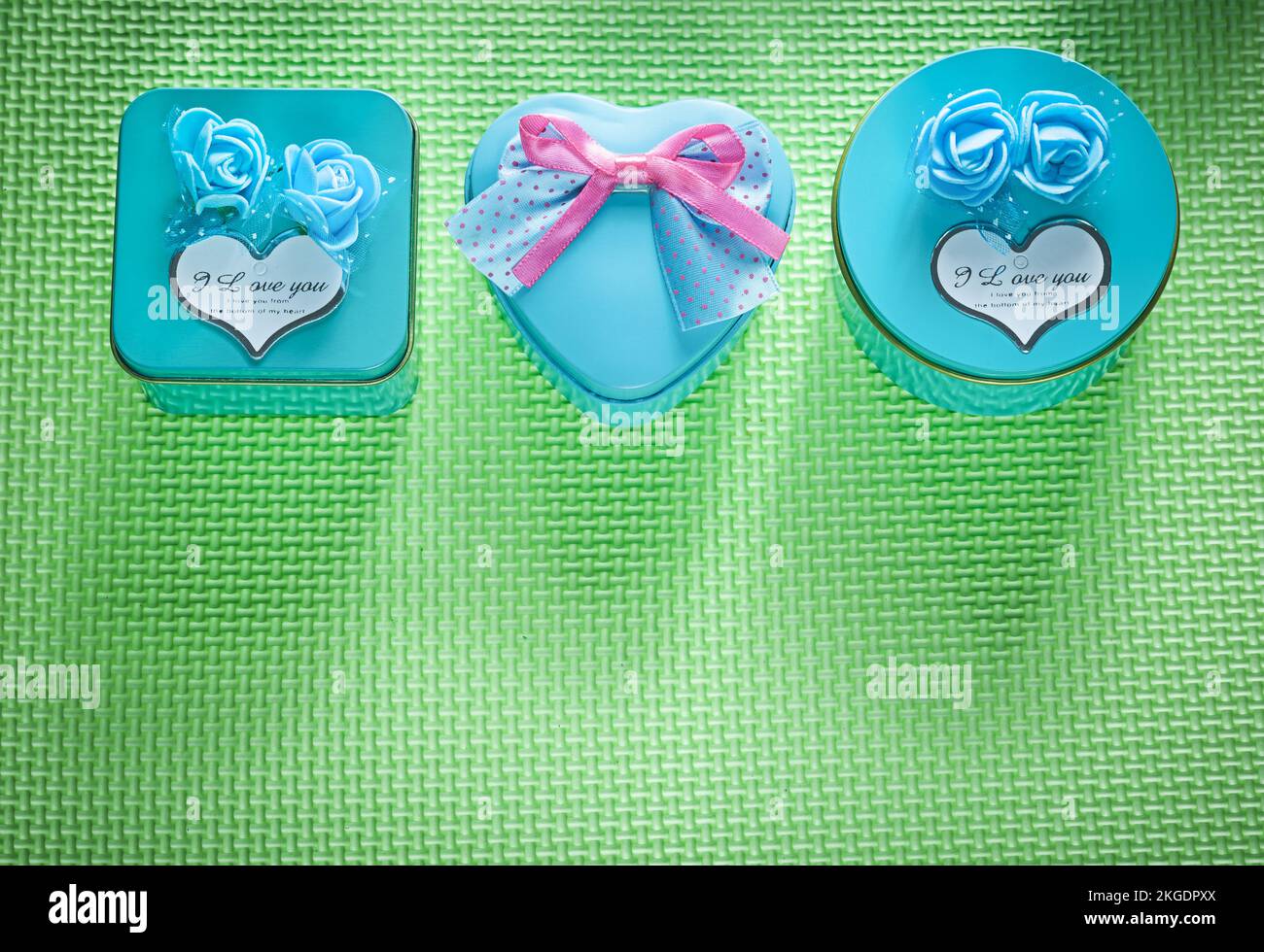 Composition of metal blue packed gift boxes on green background ...