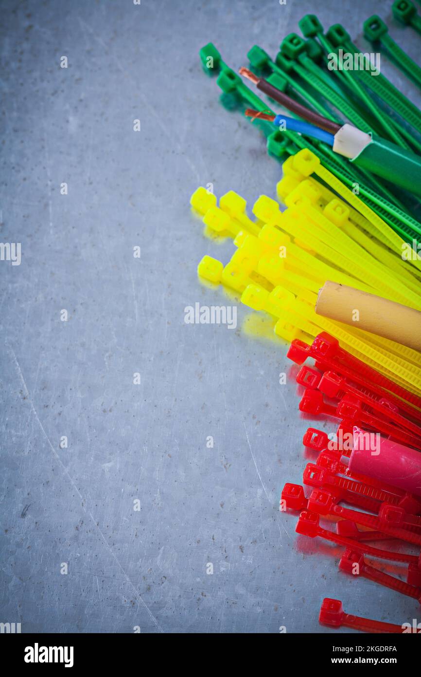 Composition of plastic cable ties on scratched metallic background ...