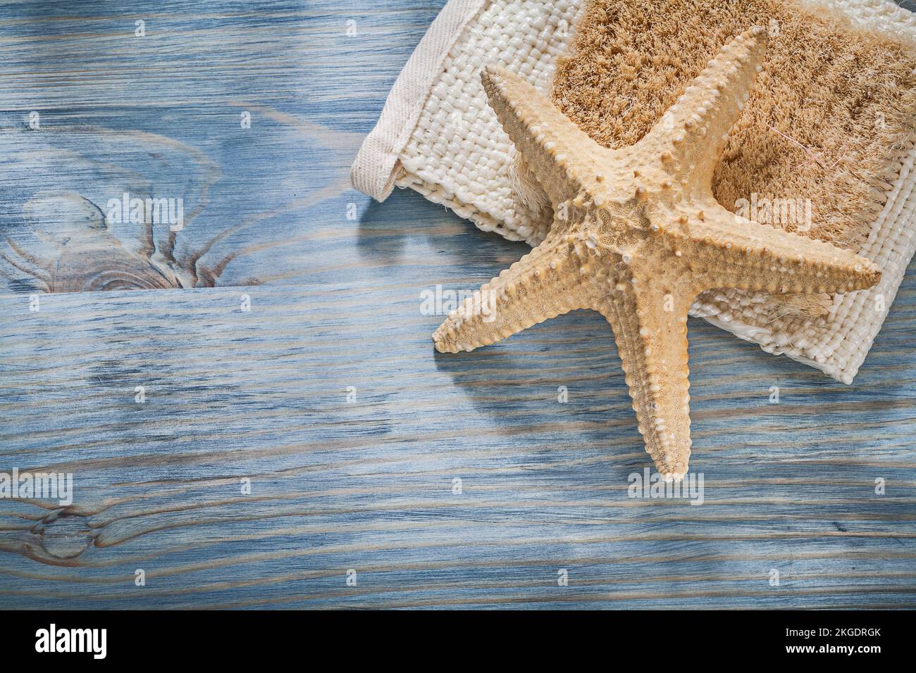Composition of starfish wisp of bast on wooden board healthcare concept ...