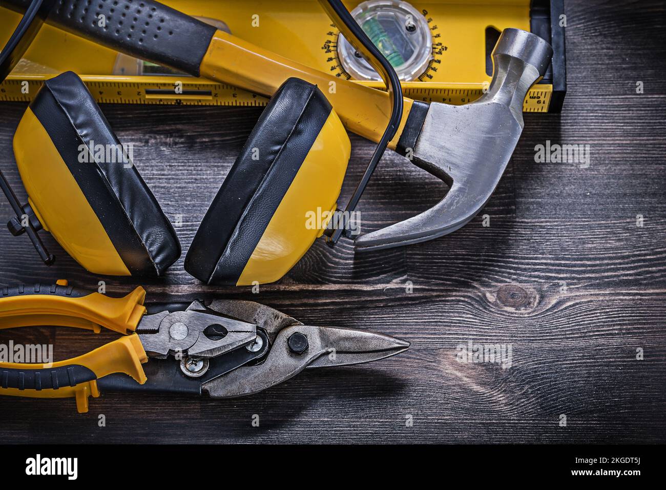 Construction level earmuffs pliers wire cutter claw hammer Stock Photo ...