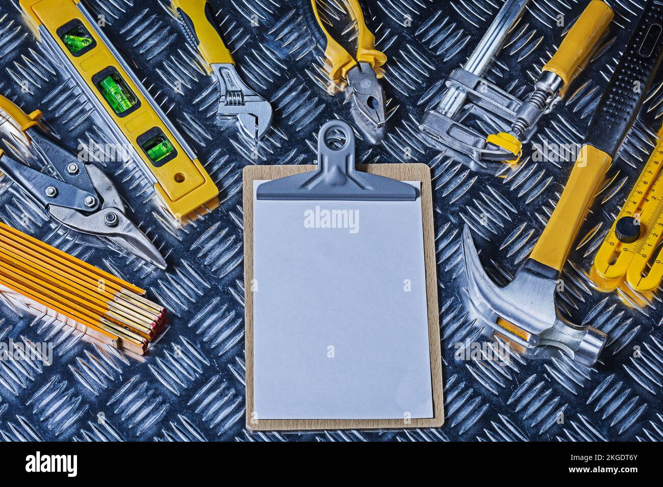 construction concept clipboard with white blank paper and many tools on ...