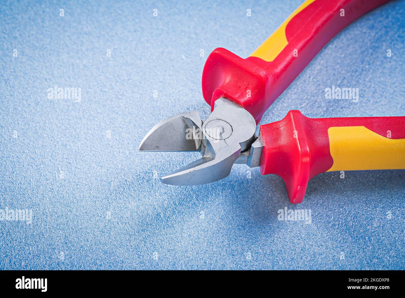 Cutting pliers on blue background electricity concept Stock Photo - Alamy