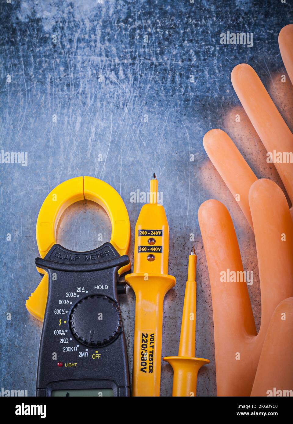 Digital ammeter electrical tester electricians rubber gloves on ...