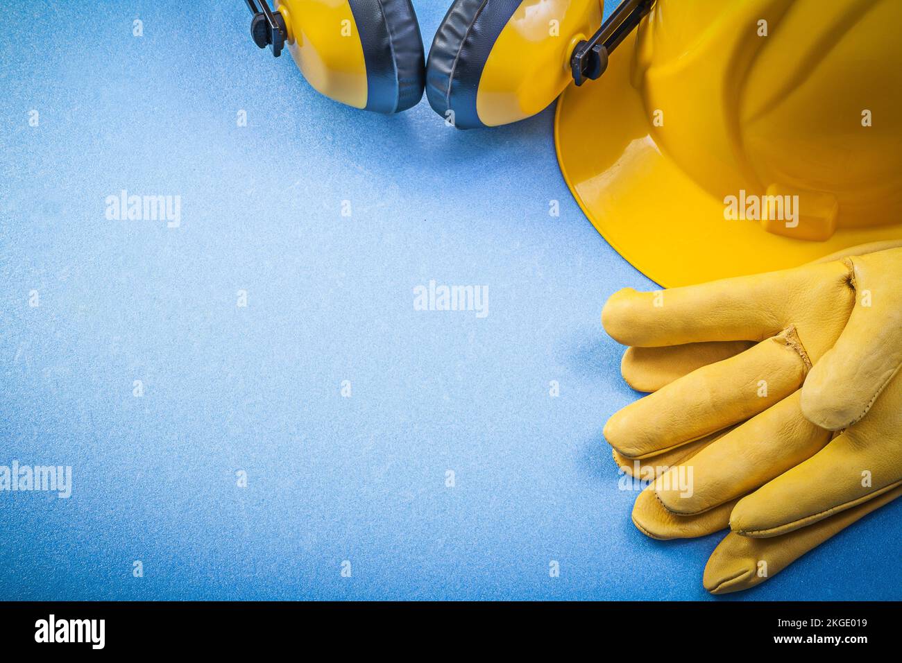 Ear muffs leather safety gloves building helmet on blue background ...
