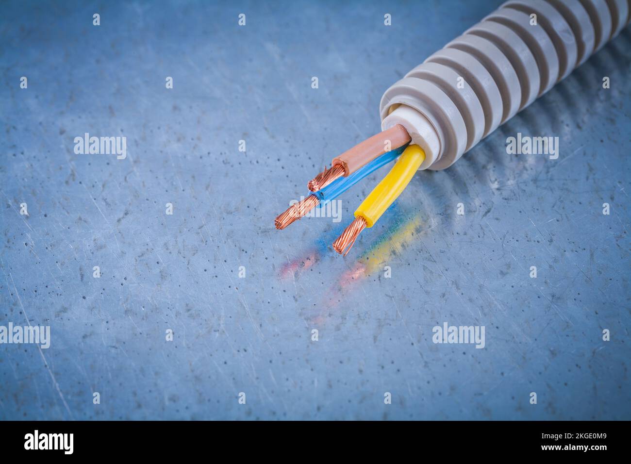 Electric corrugated wire protection copper cables on scratched metallic ...
