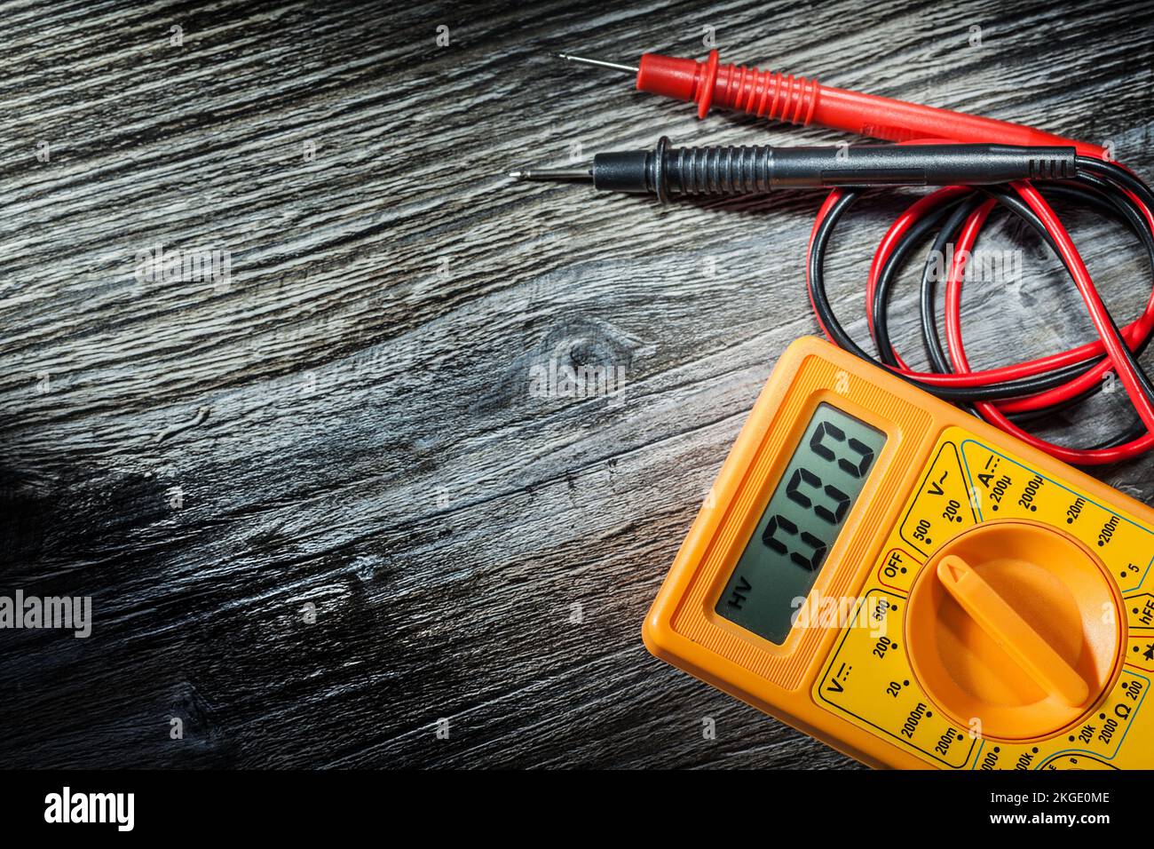 Electric multitester on wooden board Stock Photo - Alamy