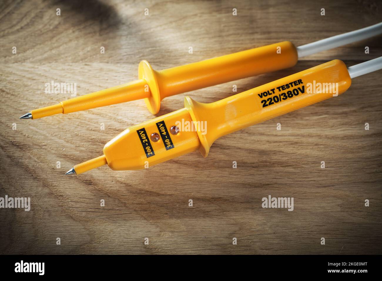 Electric tester on wooden board Stock Photo - Alamy