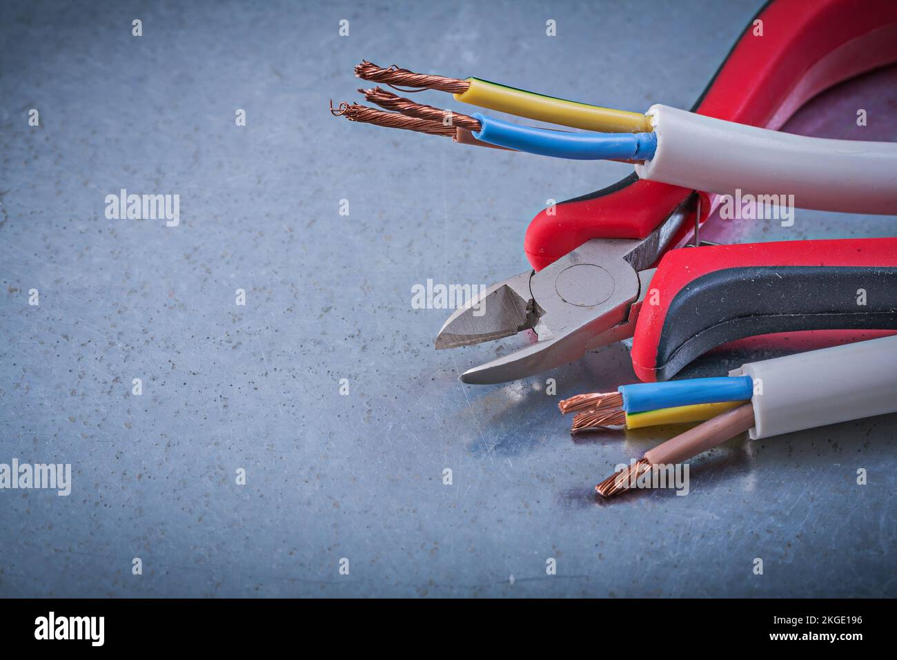 Electrical cables wires nippers on scratched metallic background ...