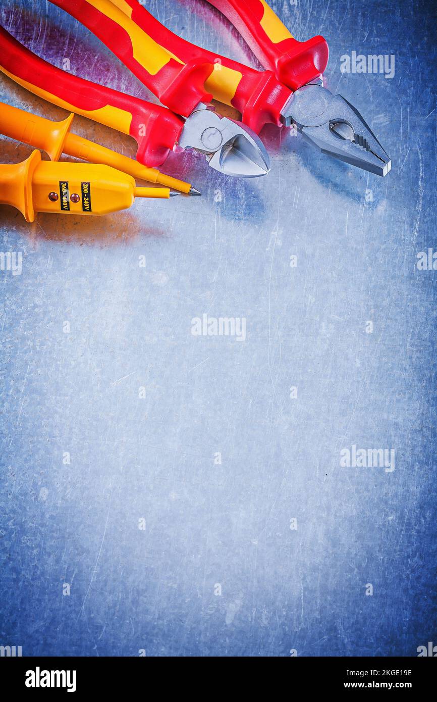 Electrical tester pliers nippers on scratched metallic background ...