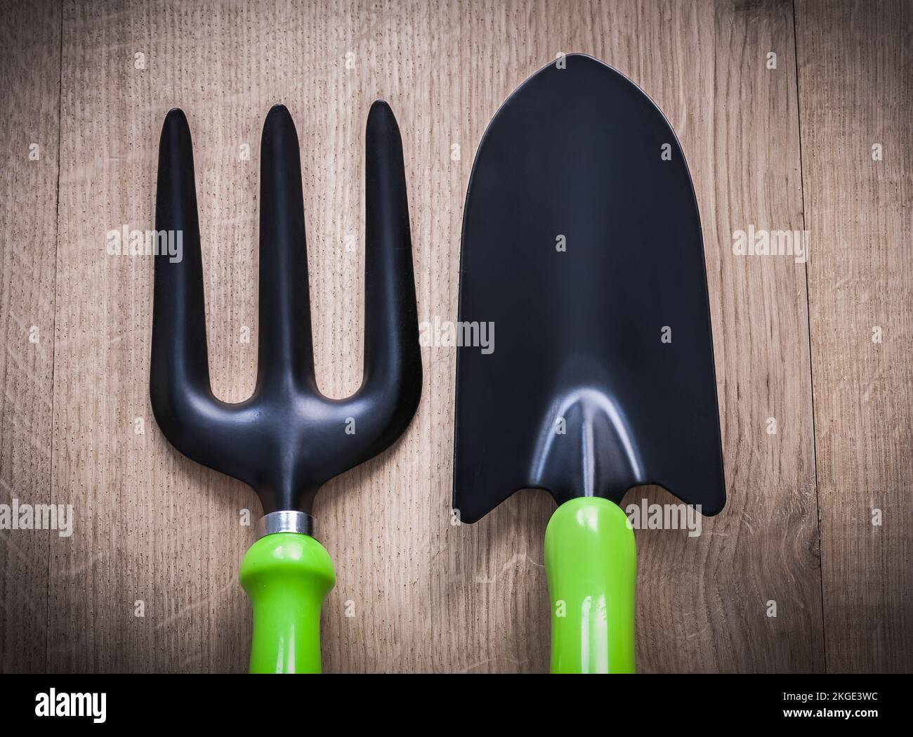 Gardening hand spade with trowel fork on wooden surface agriculture ...