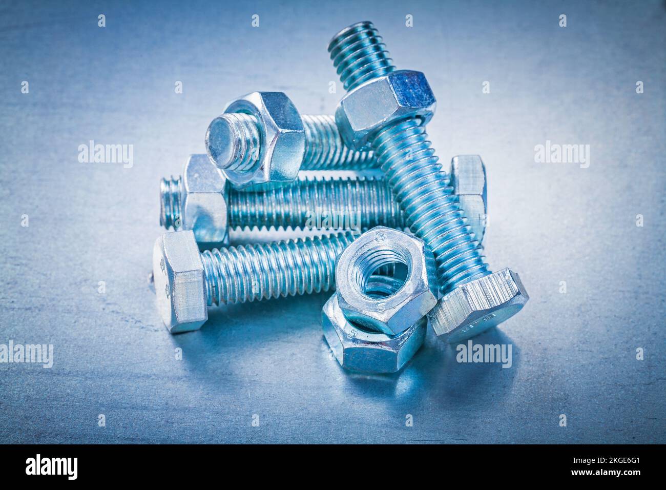 Group of metal screw nuts and bolts on metallic background construction ...