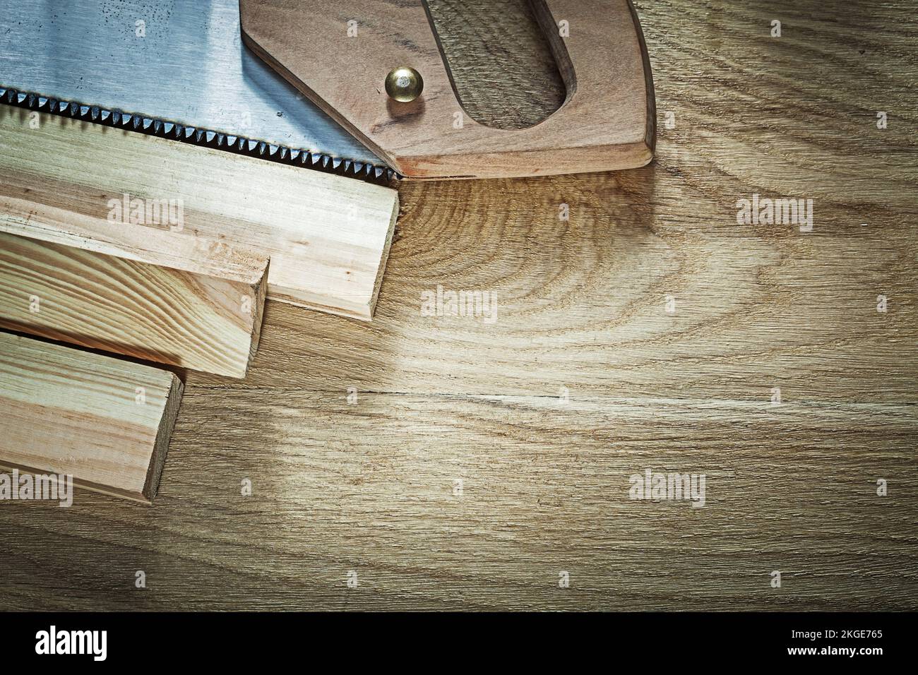Hacksaw wooden stud on wood board construction concept Stock Photo - Alamy