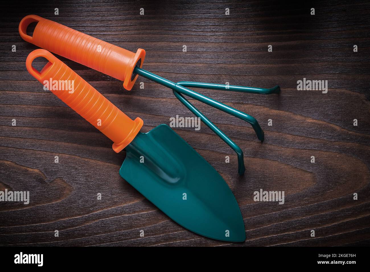 Hand gardening spade with trowel fork on vintage wood board agriculture ...