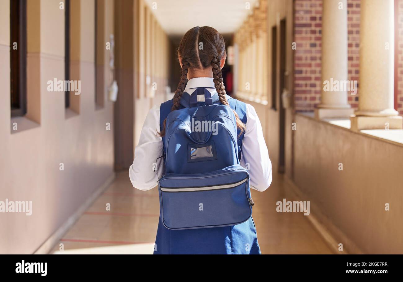 Girl student, backpack and walking in a school back for study ...