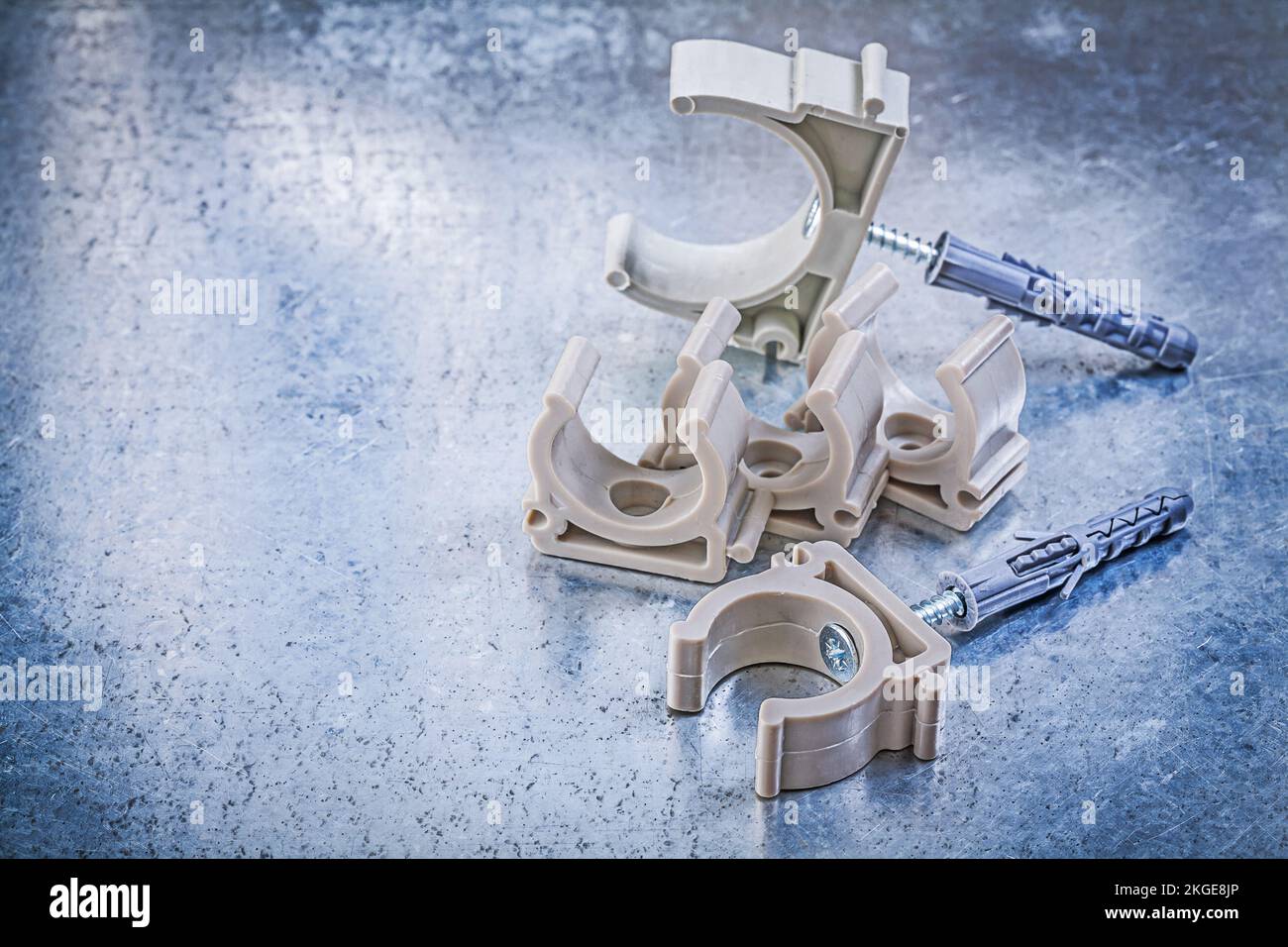 Heap of water pvc pipe clamps on metallic surface construction concept ...