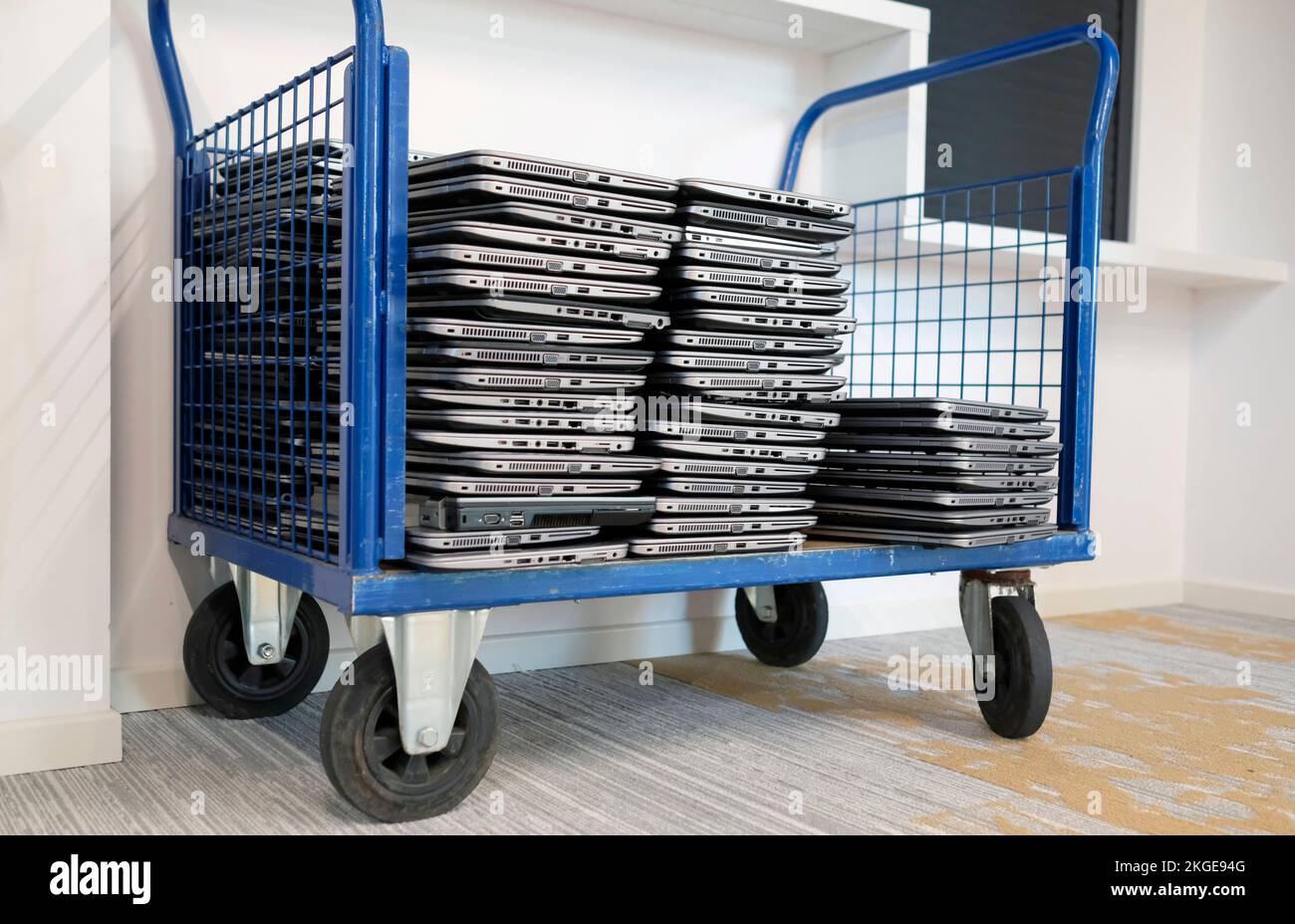 Big stacks of discarded laptops, notebooks on a trolley Stock Photo - Alamy