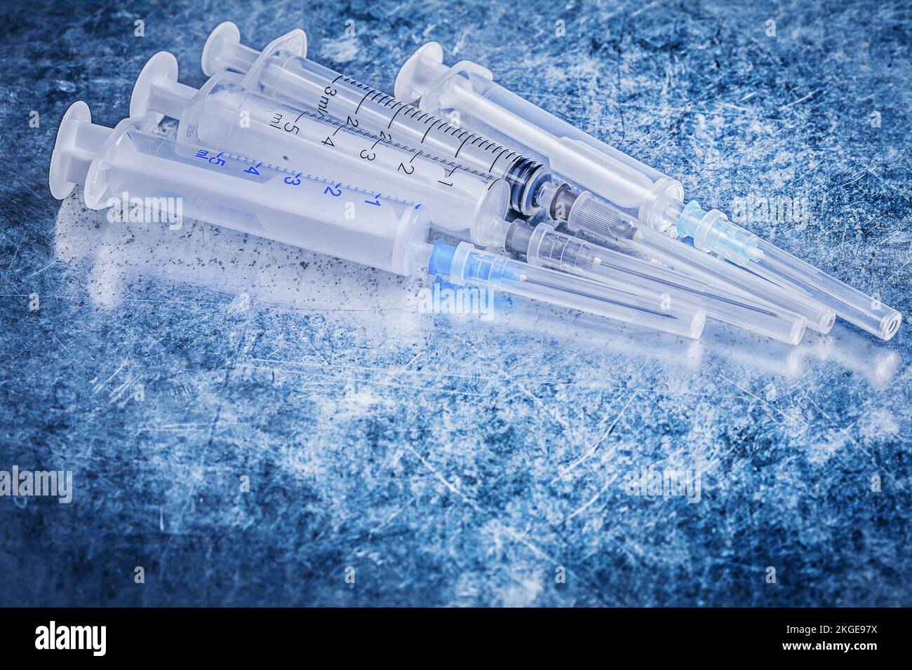 Injectors on scratched metallic background medicine concept Stock Photo ...